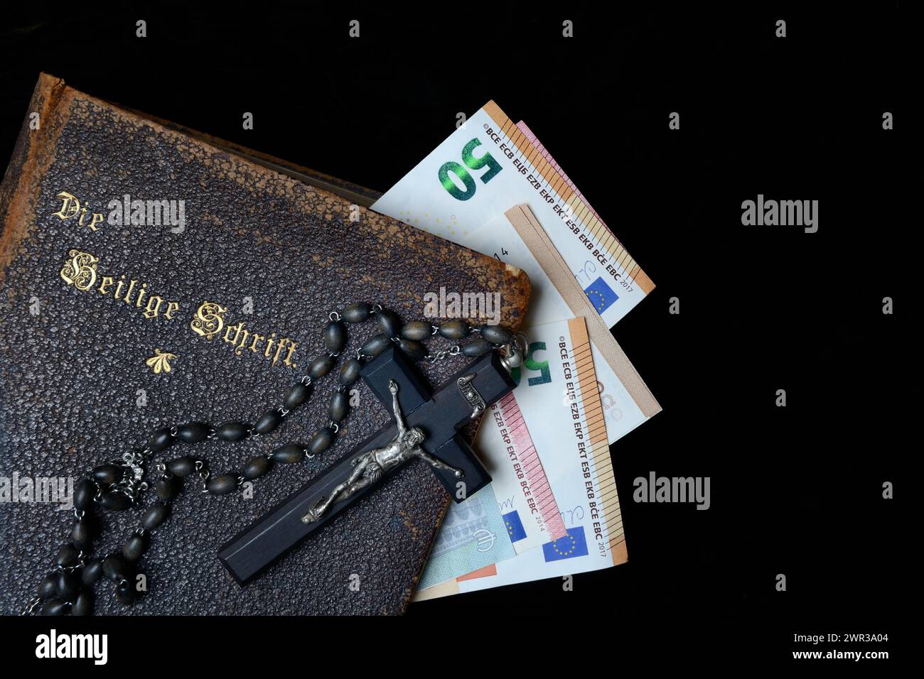 Bible, crucifix and banknotes, church and money, church tax Stock Photo ...