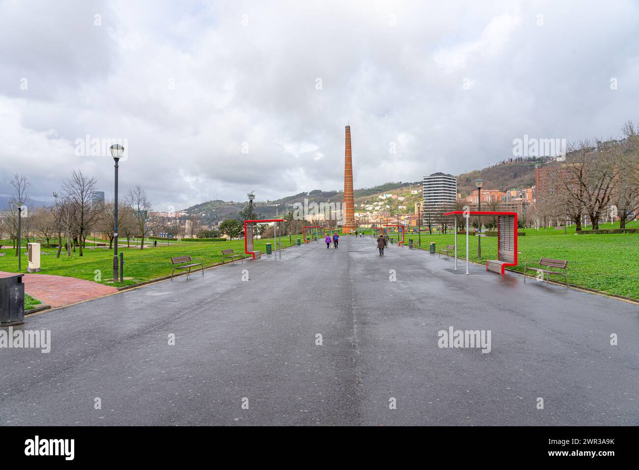 urban park with large industrial chimney preserved in the center of ...