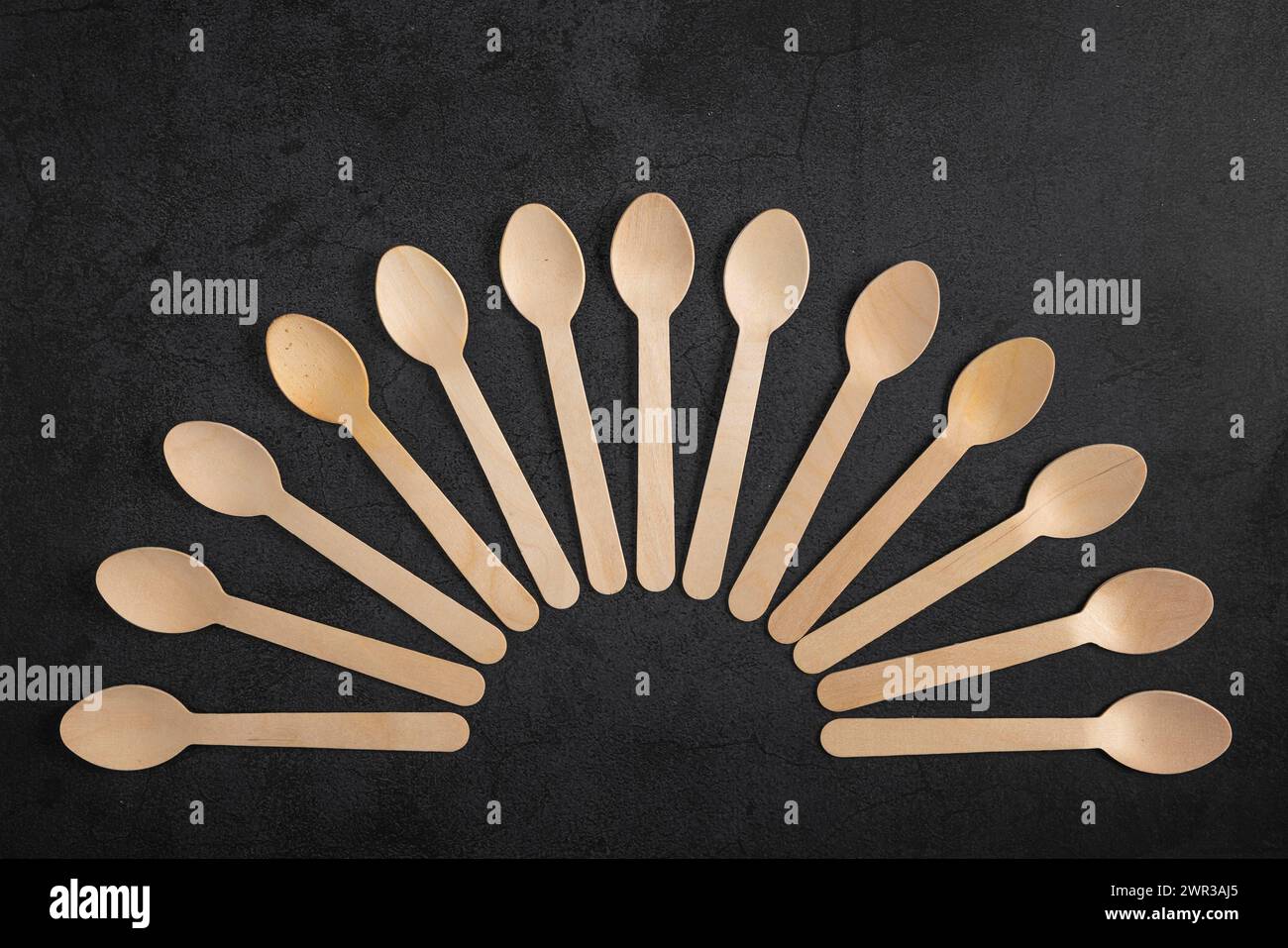 Fan-shaped arrangement of wooden spoons on a dark background Stock ...