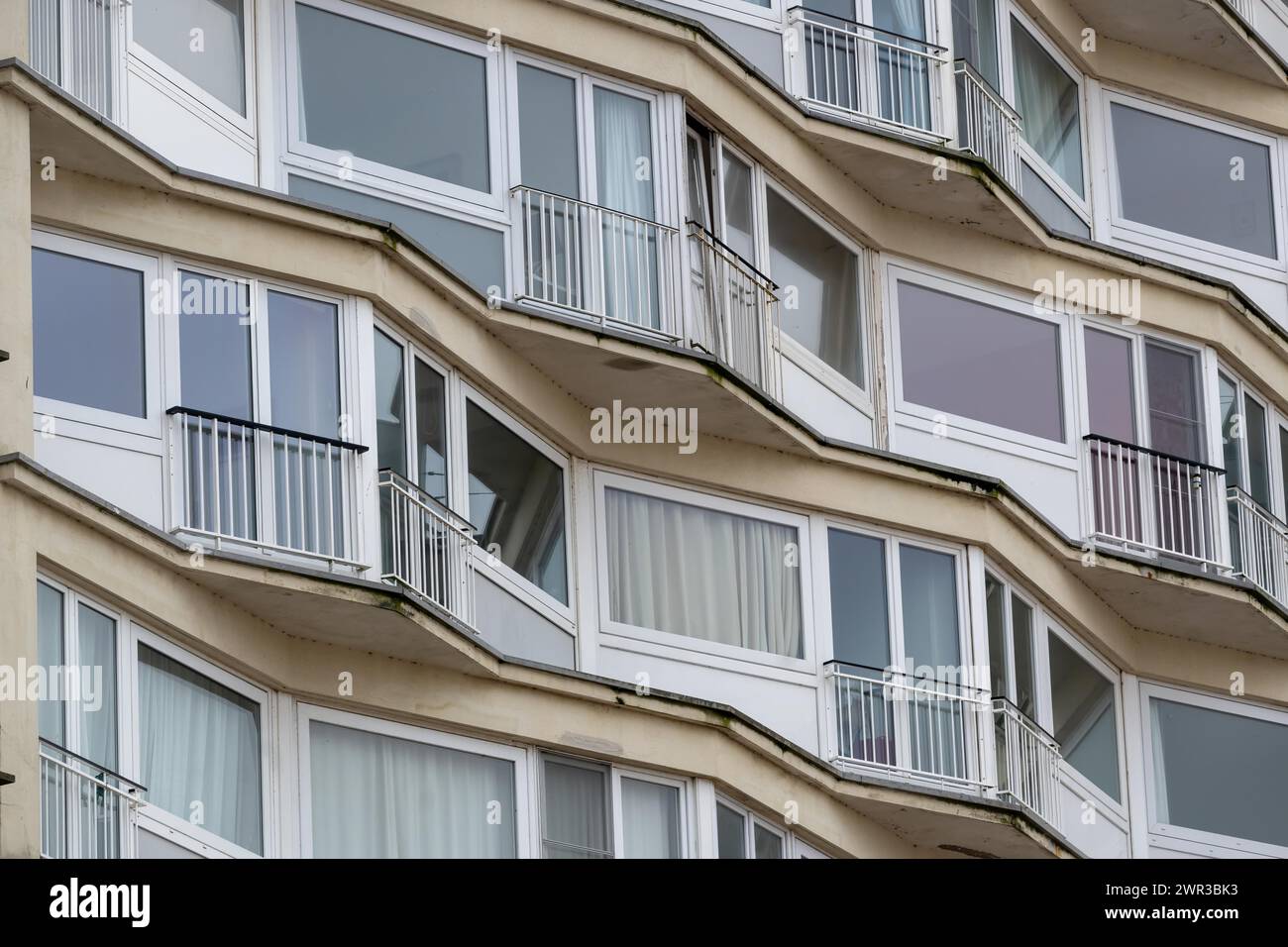 Curved residential building with curved balconies and reflective ...