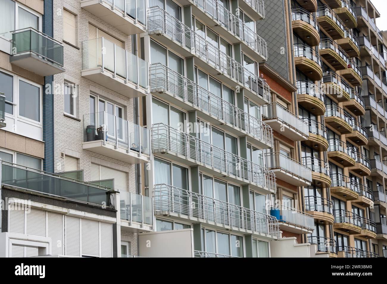 Stack of flat balconies with glass railings on a multi-storey building ...