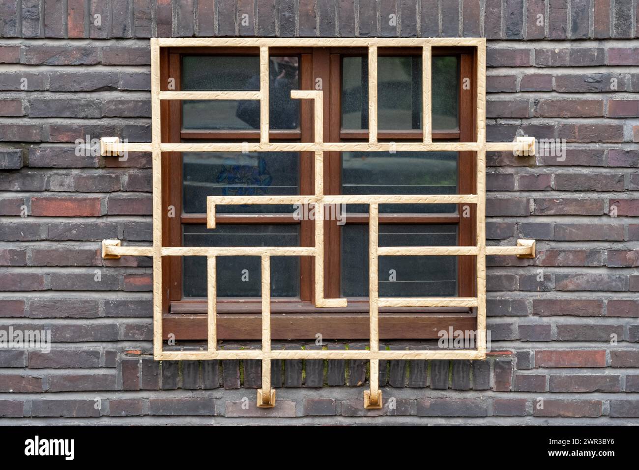 Lattice wooden window in Art Nouveau style, embedded in a brick wall ...