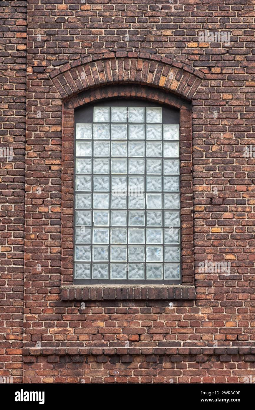 An arched window with glass bricks in a detailed brick wall Stock Photo ...