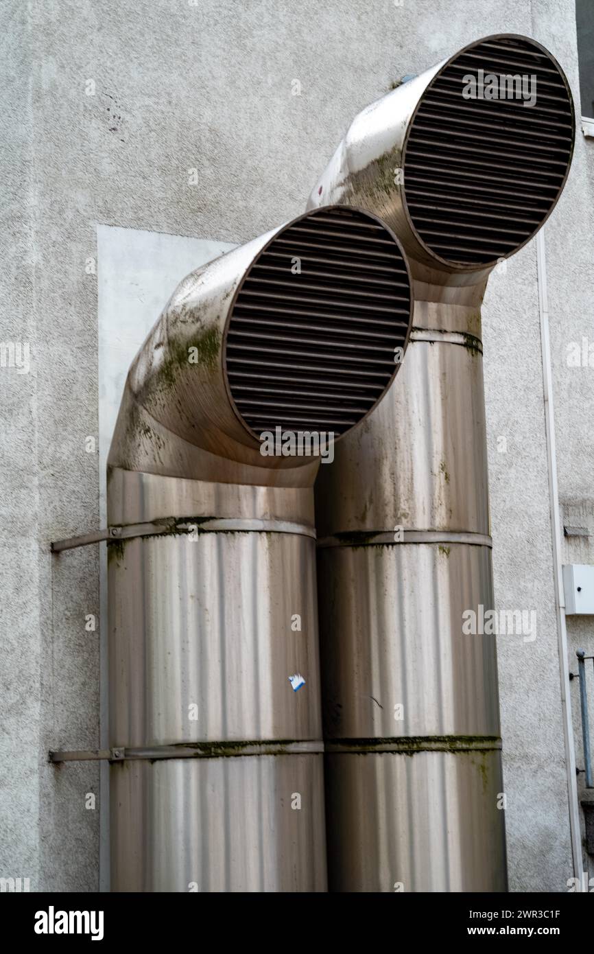 Two large metal, circular ventilation pipes on a building wall Stock ...
