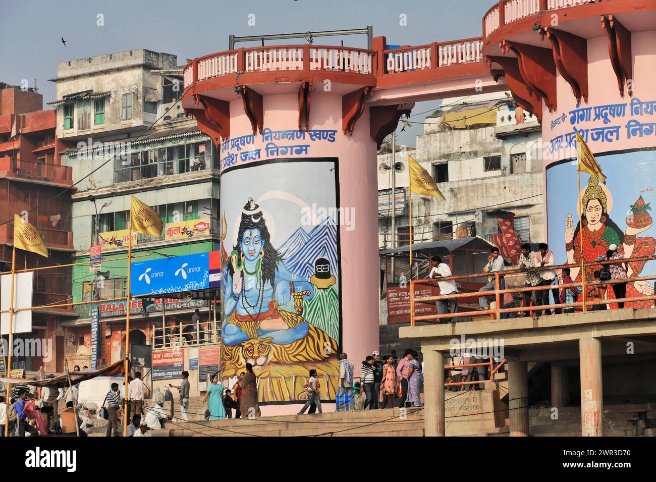 Traditional religious paintings on a building with people and pillars ...
