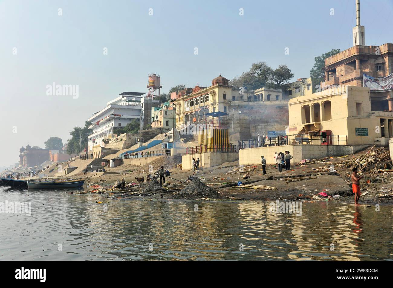 Urban riverbank with people living everyday life, framed by a ...