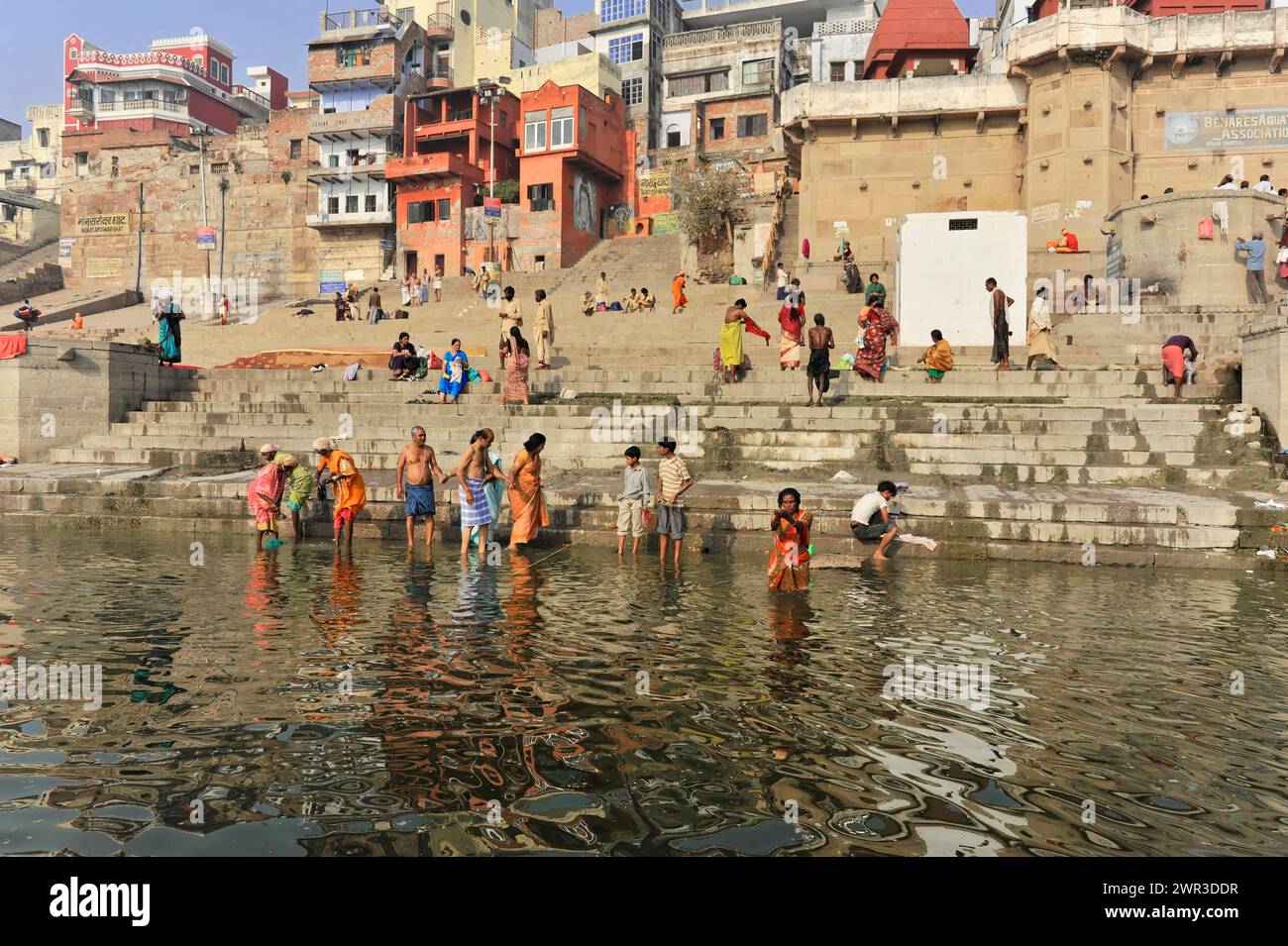 Groups of people standing in water and interacting in urban environment ...