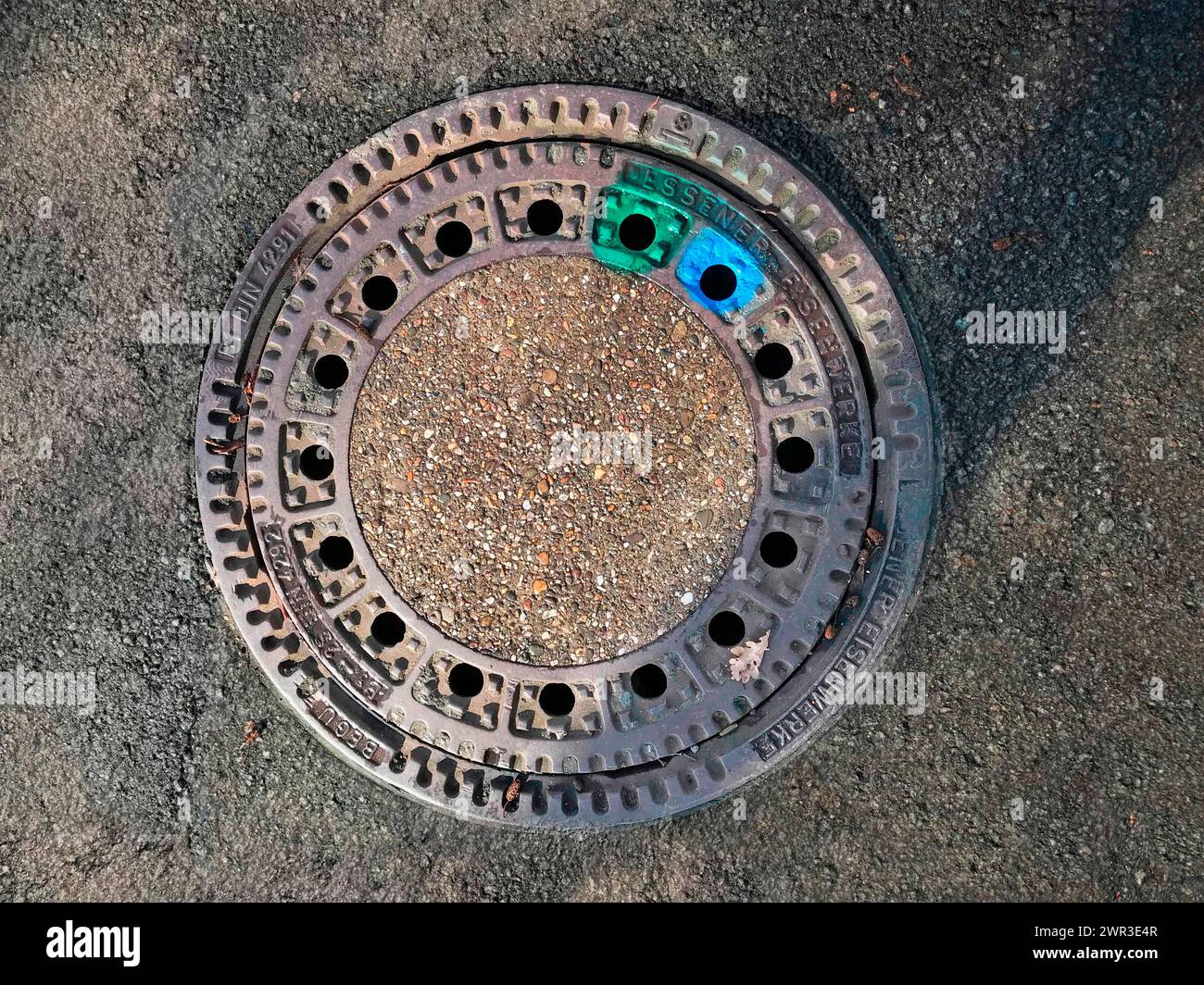 Colour-coded manhole cover Stock Photo - Alamy