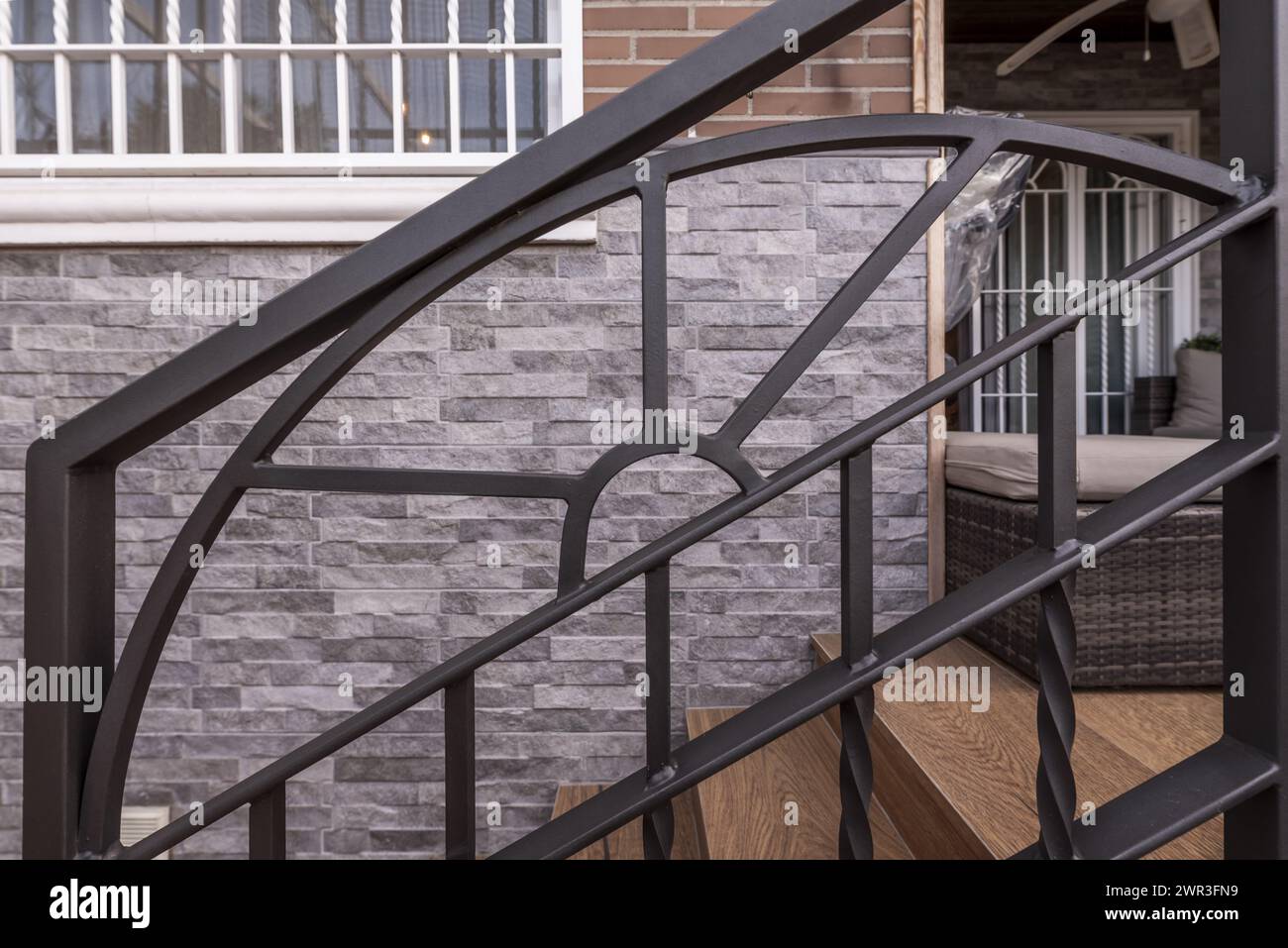 Metal railing of a small staircase in the patio of a residential home ...