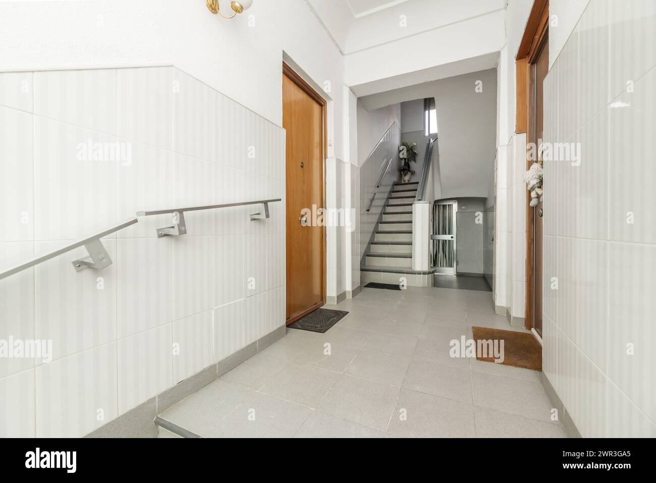 Access portal to a residential apartment building with tiled walls and ...