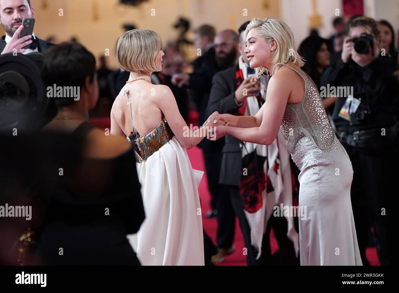 Julianne Hough, left, and Florence Pugh arrive at the Oscars on Sunday, March 10, 2024, at the ...