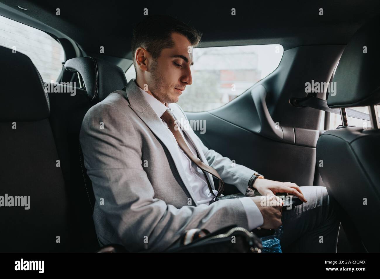 Business professional in a suit sitting inside a car Stock Photo - Alamy