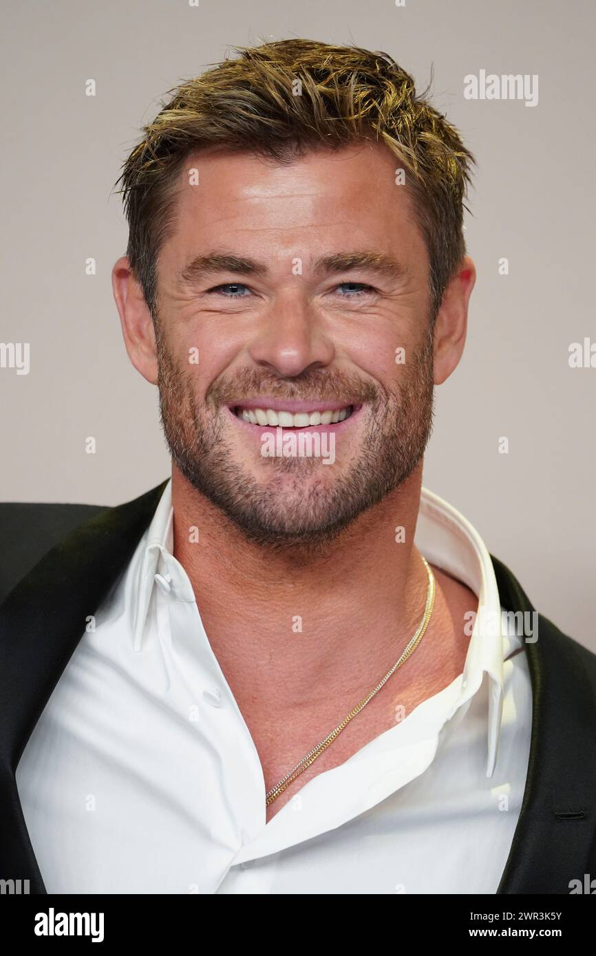 Chris Hemsworth poses in the press room at the Oscars on Sunday, March ...