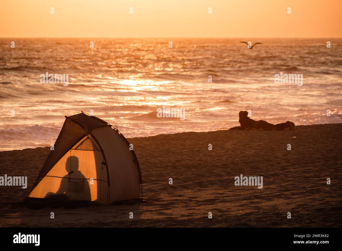 People enjoying the beach and sunset on Venice Beach in California USA ...