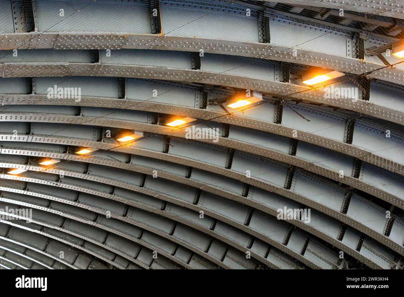 Underside of an iron work railway bridge Stock Photo - Alamy
