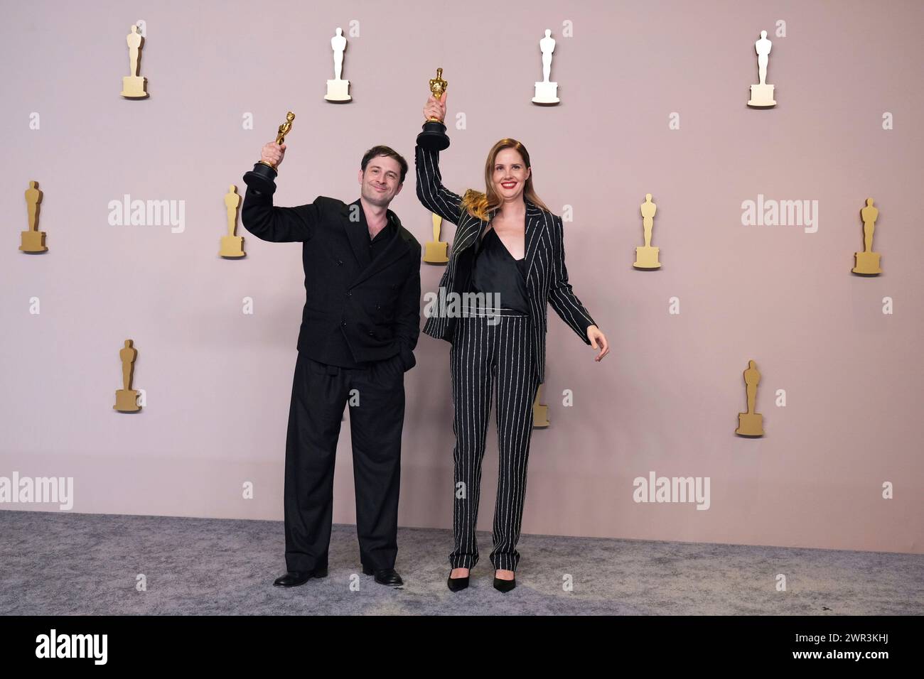Arthur Harari, left, and Justine Triet pose with the award for best ...
