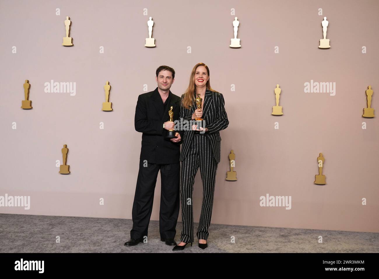 Arthur Harari, left, and Justine Triet pose with the award for best ...