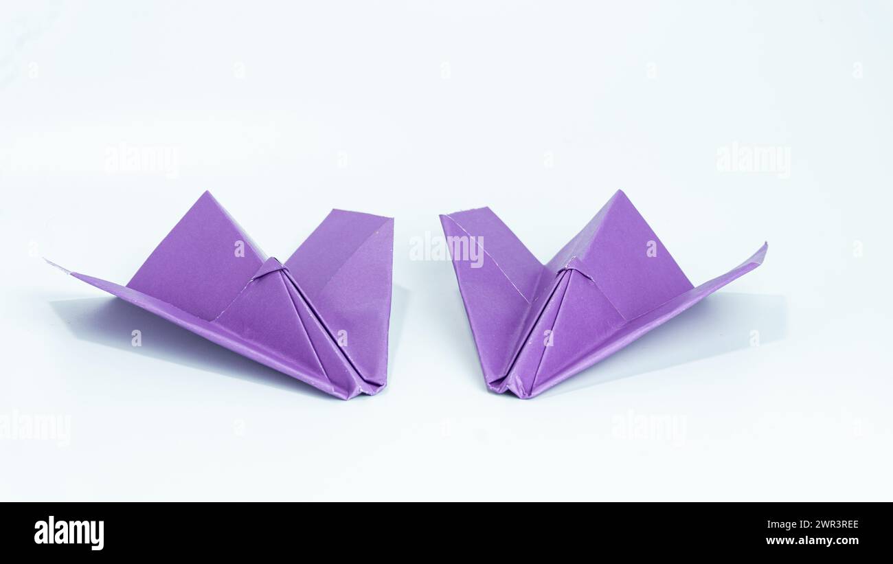 Purple paper airplane isolated on white background Stock Photo - Alamy
