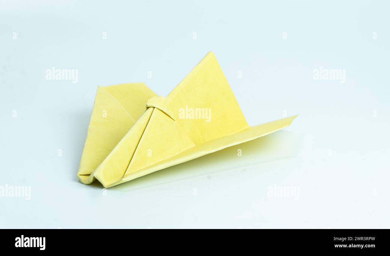 Yellow paper airplane isolated on white background Stock Photo - Alamy