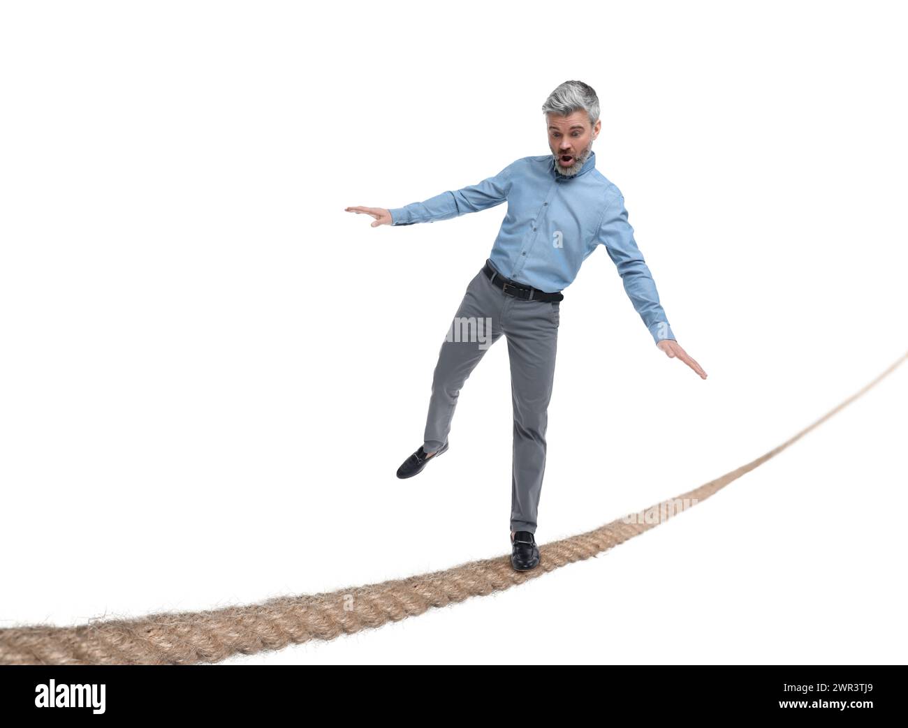 Risks and challenges of owning business. Man balancing on rope against ...