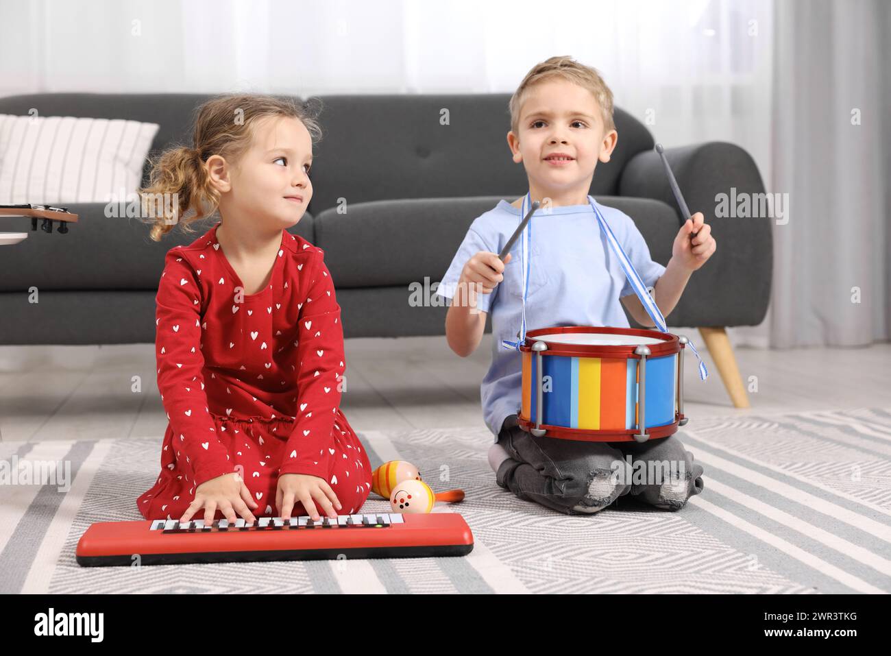 Little children playing toy musical instruments at home Stock Photo - Alamy