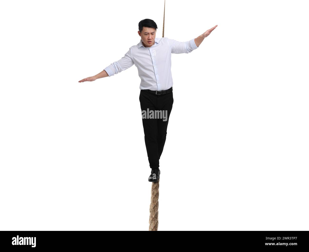 Risks and challenges of owning business. Man balancing on rope against ...