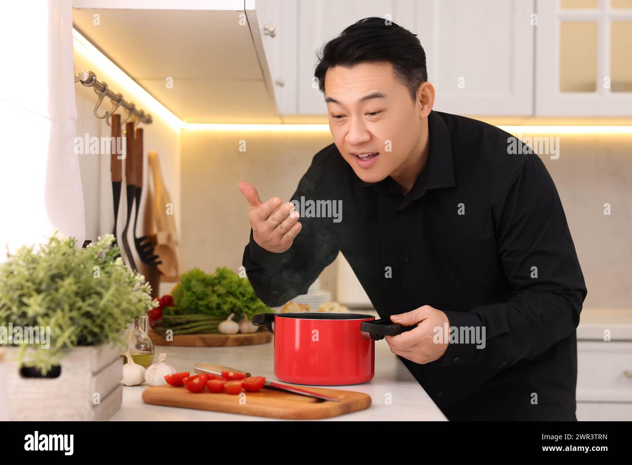 Smelling tomatoes hi-res stock photography and images - Alamy