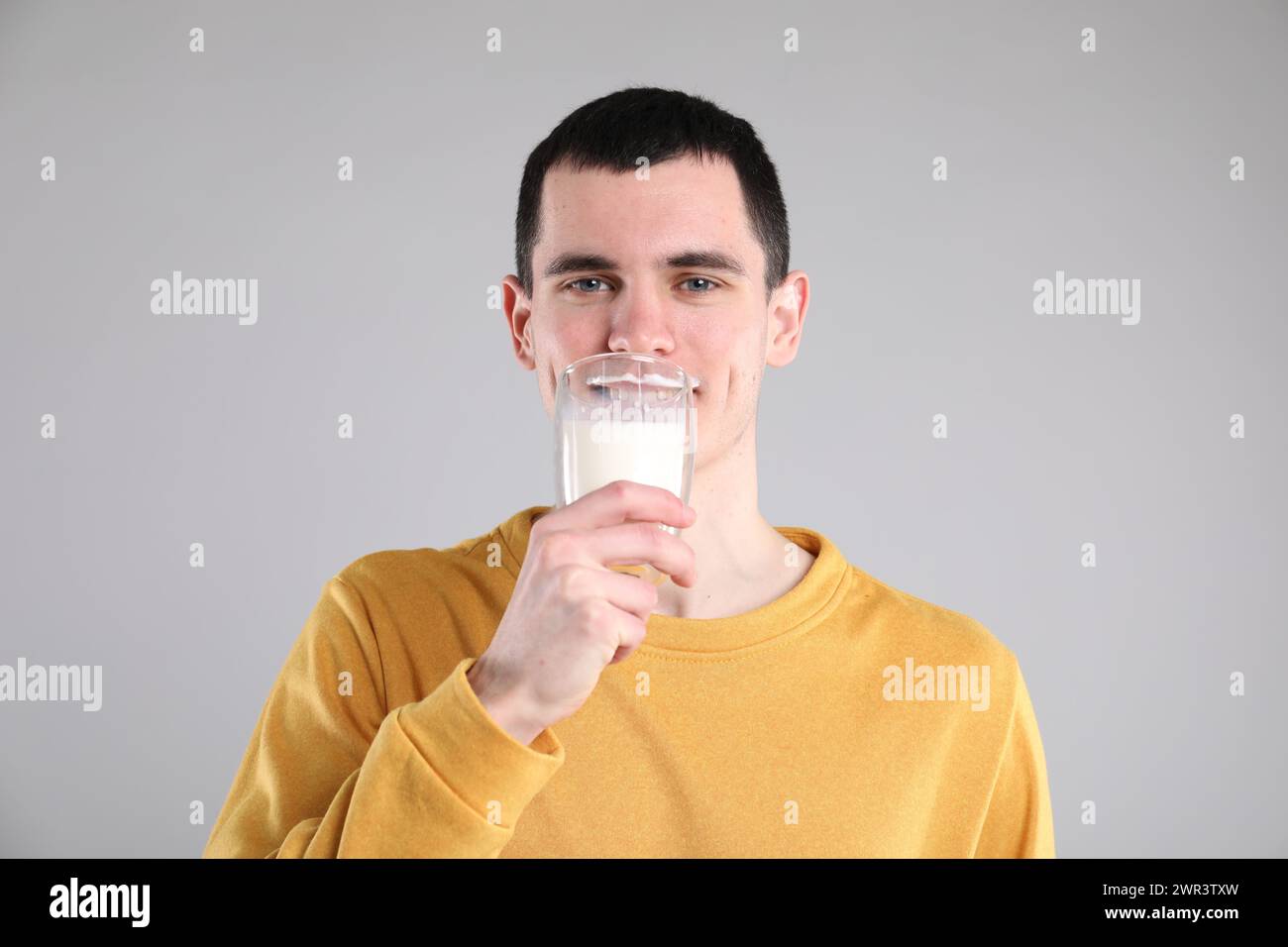 Milk mustache left after dairy product. Man drinking milk on gray background Stock Photo - Alamy