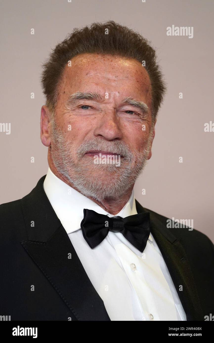 Arnold Schwarzenegger poses in the press room at the Oscars on Sunday ...