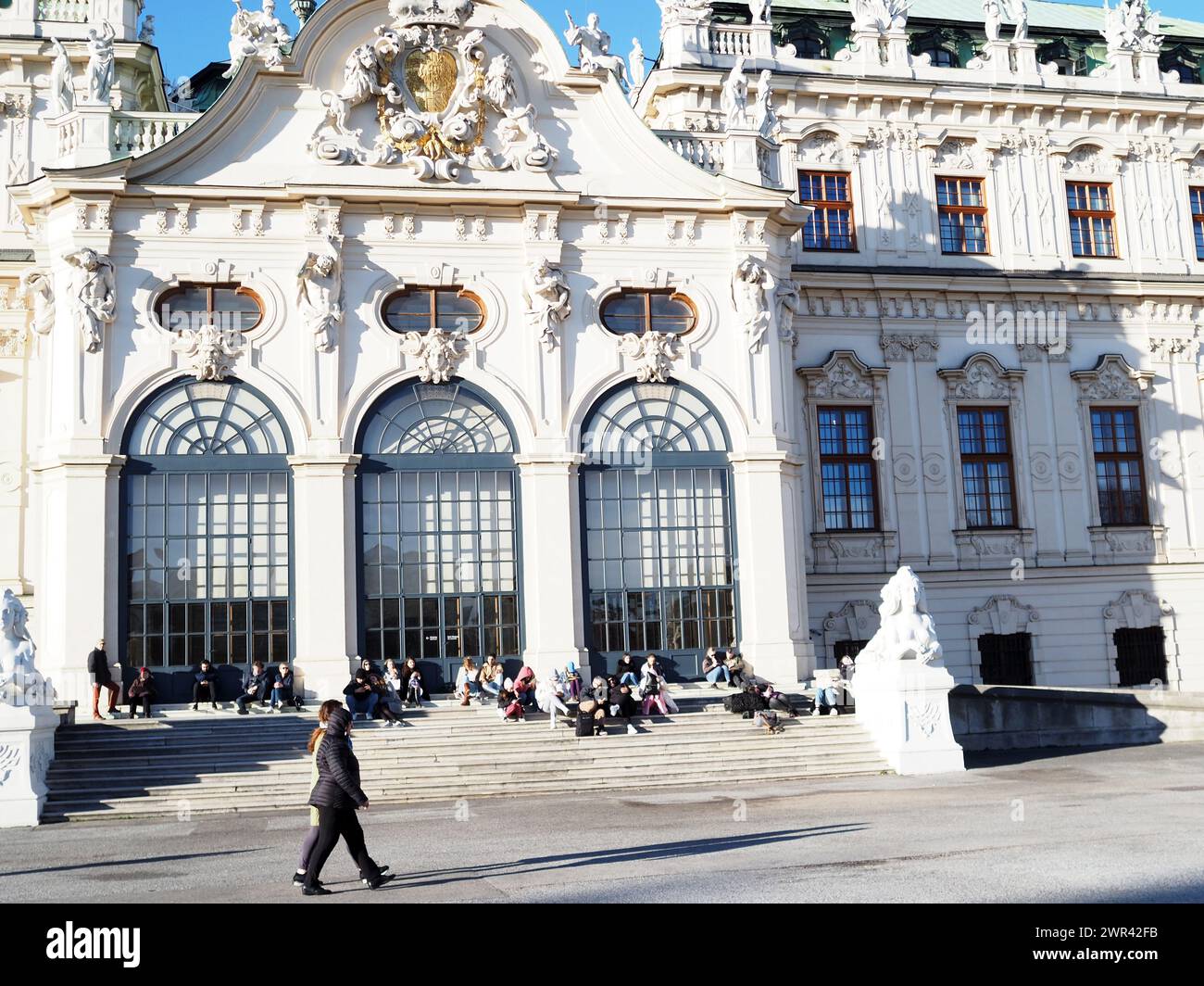 Vienna, Austria - February 25, 2024: Tourists sit on the steps of the ...
