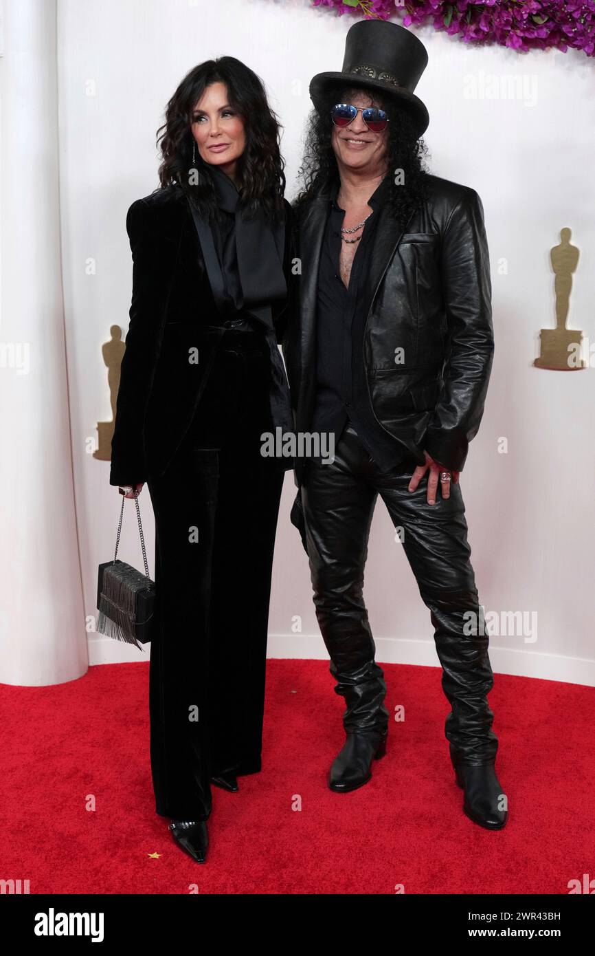 From left, Meegan Hodges and Slash arrive at the Oscars on Sunday ...