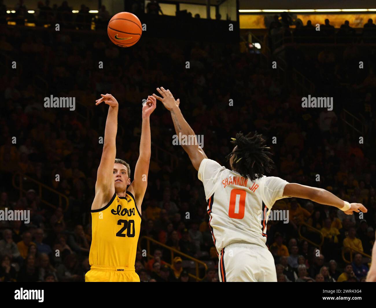 Iowa forward Payton Sandfort (20) takes a three point shot under ...