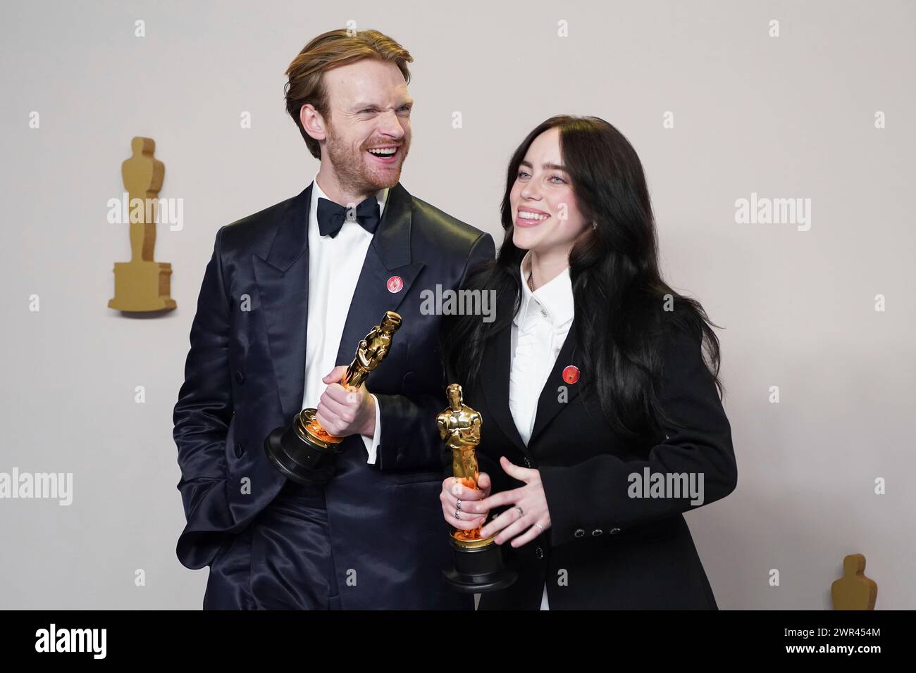 Finneas O'Connell, left, and Billie Eilish pose in the press room with ...