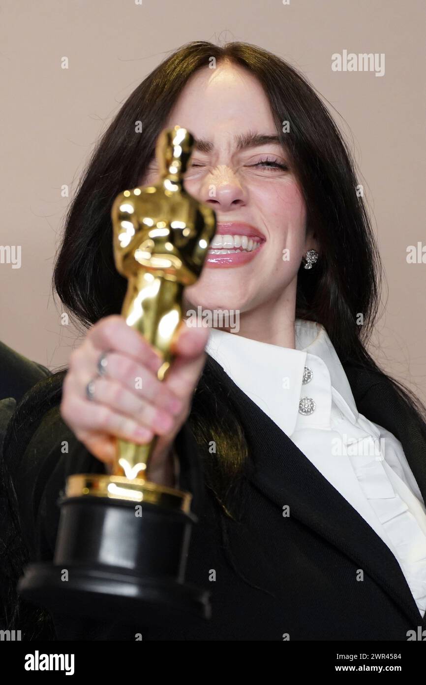 Billie Eilish poses in the press room with the award for best original ...