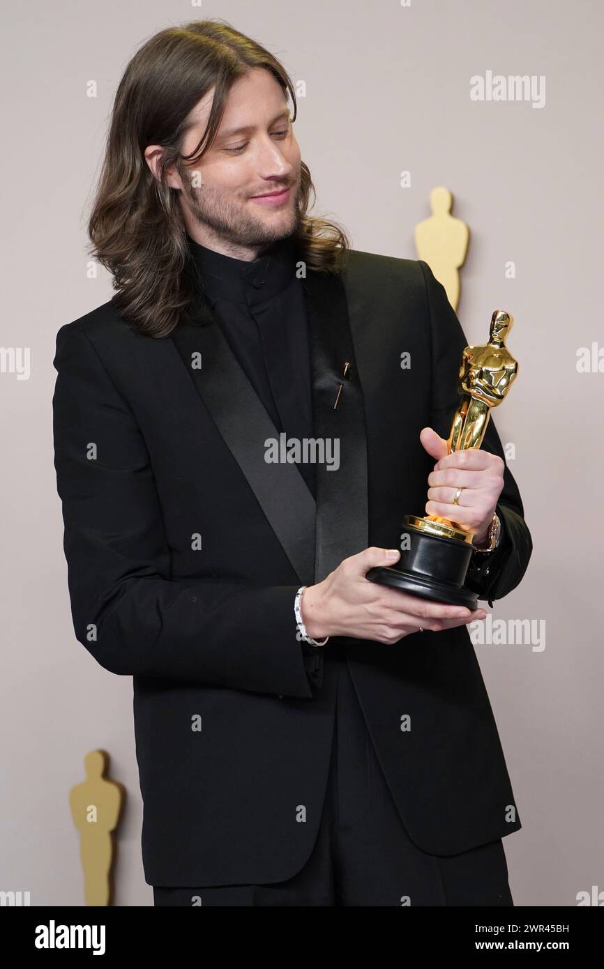 Ludwig Goransson poses in the press room with the award for best ...