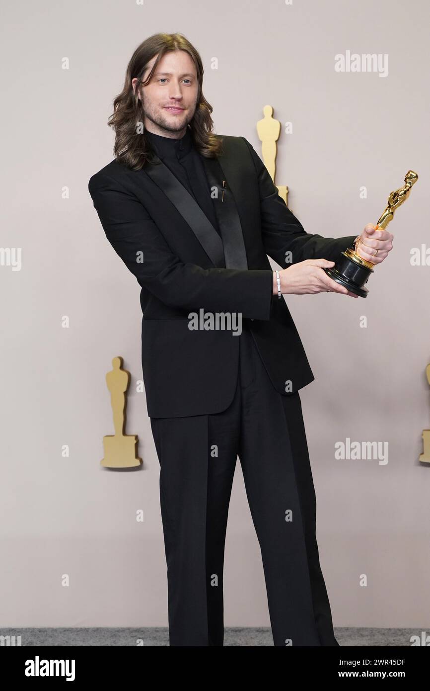 Ludwig Goransson poses in the press room with the award for best ...
