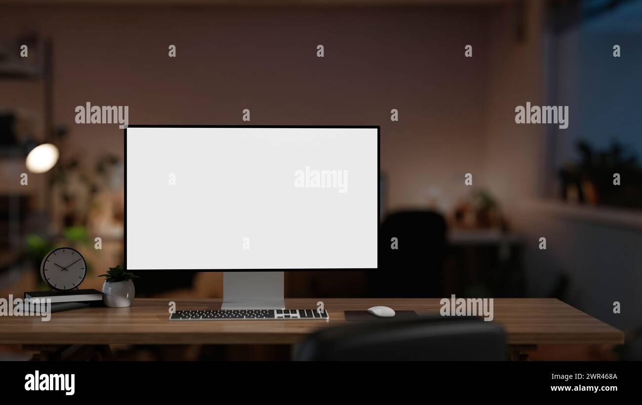 A contemporary home office at night features a white-screen computer ...