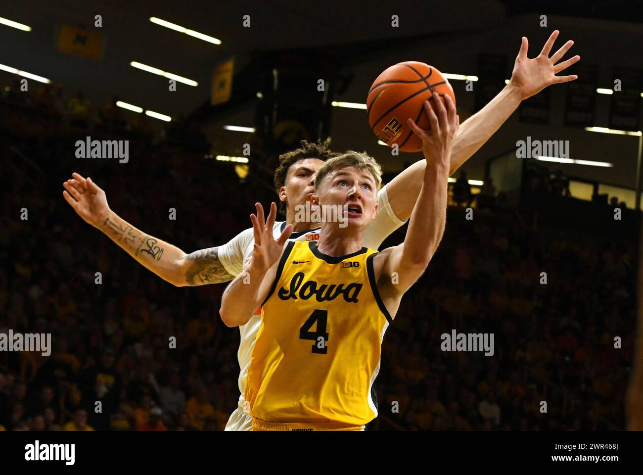 Iowa guard Josh Dix (4) heads to the basket under pressure from ...