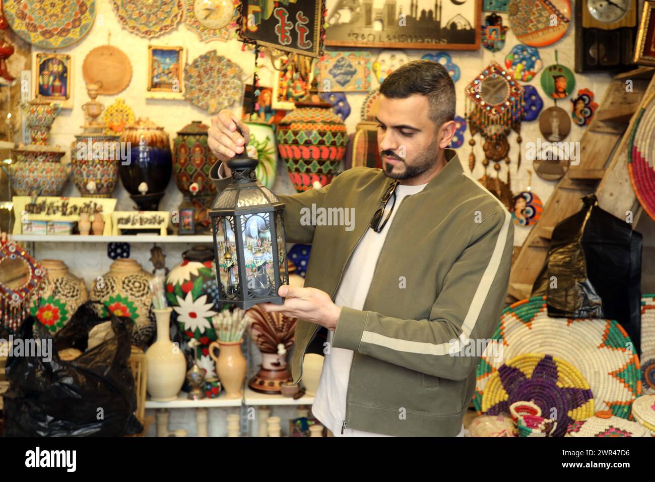Baghdad, Iraq. 4th Mar, 2024. A man views a Ramadan lantern at a store in Baghdad, Iraq, March 4 ...