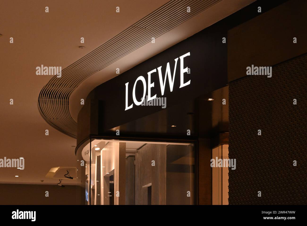 the storefront of LOEWE, Elegant LOEWE Storefront Signage Illuminated ...