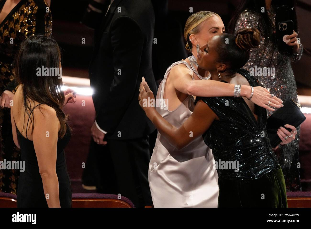 Charlize Theron, left, embraces Issa Rae during the Oscars on Sunday ...