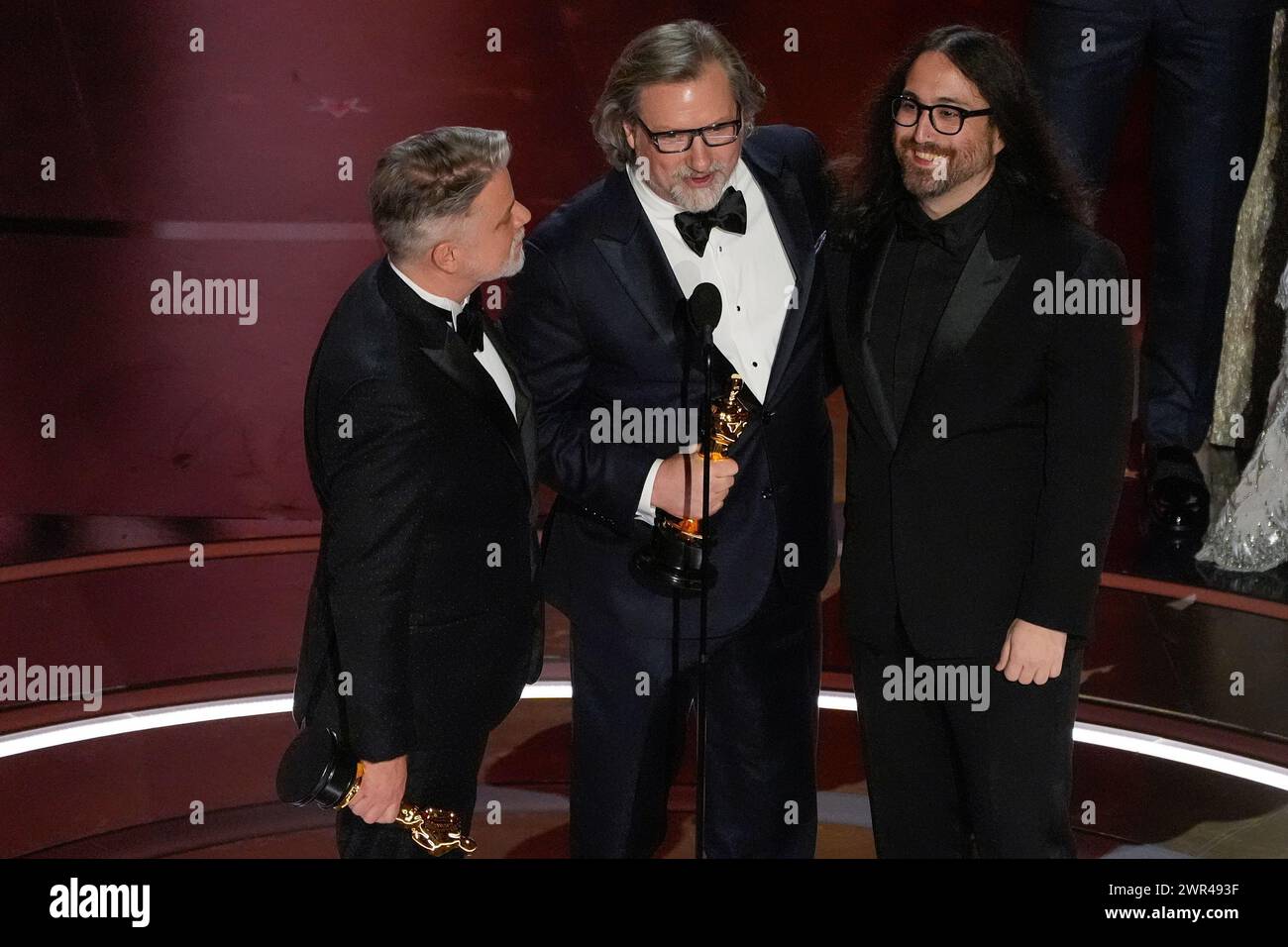 Dave Mullins, from left, Brad Booker, and Sean Ono Lennon accept the ...