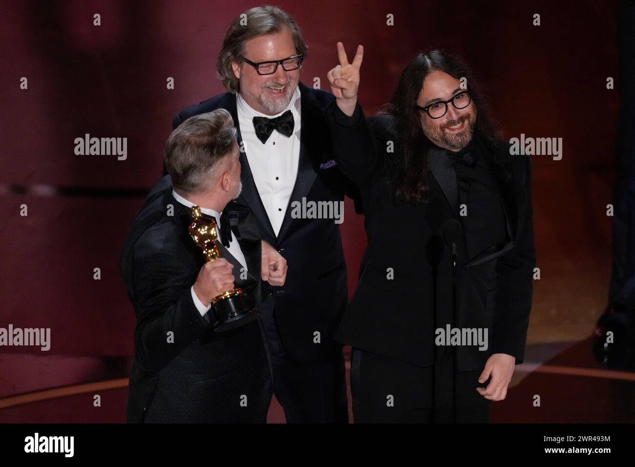 Dave Mullins, from left, Brad Booker, and Sean Ono Lennon accept the ...