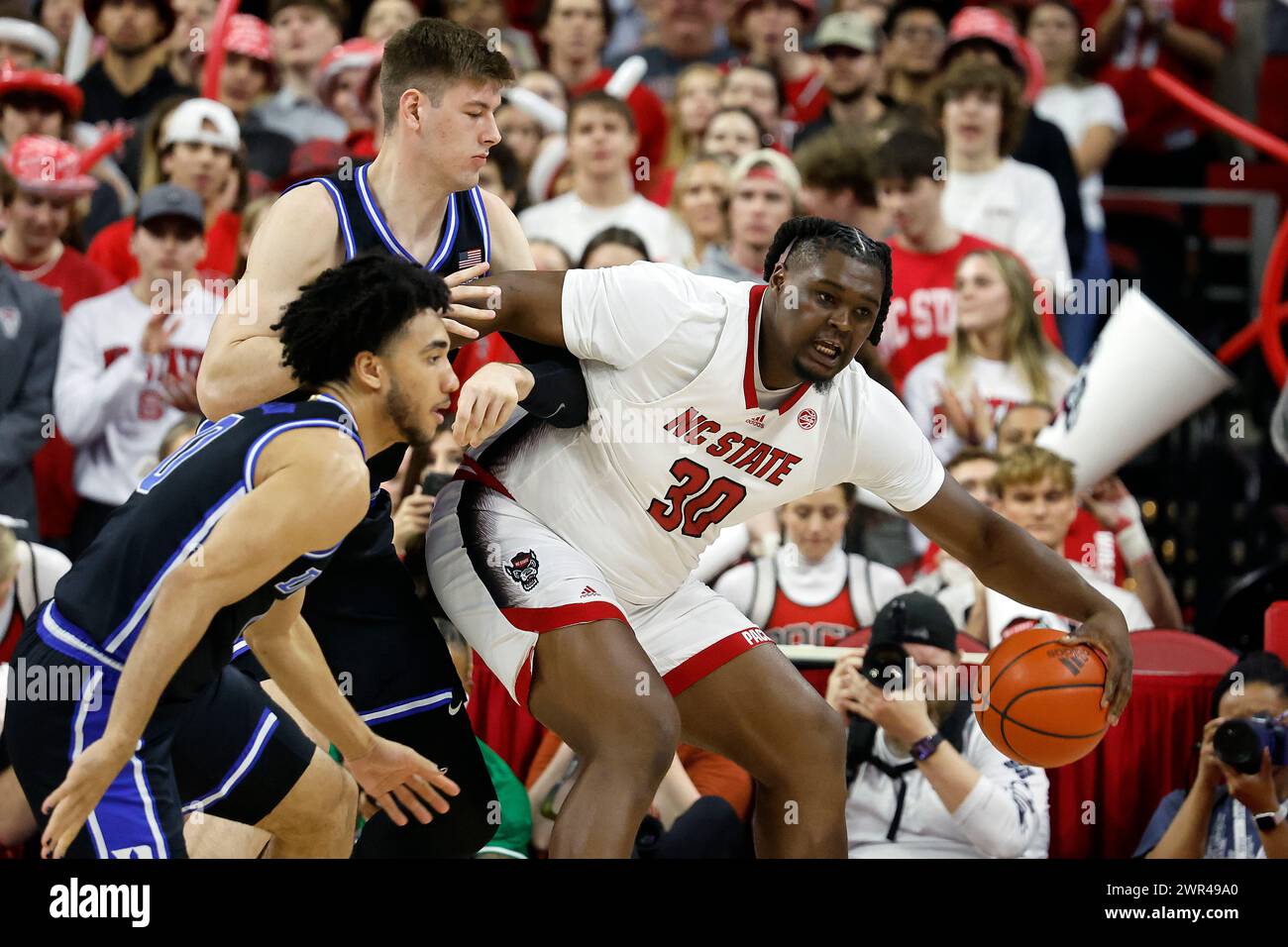 North Carolina State's DJ Burns Jr. (30) tries to drive the ball past ...