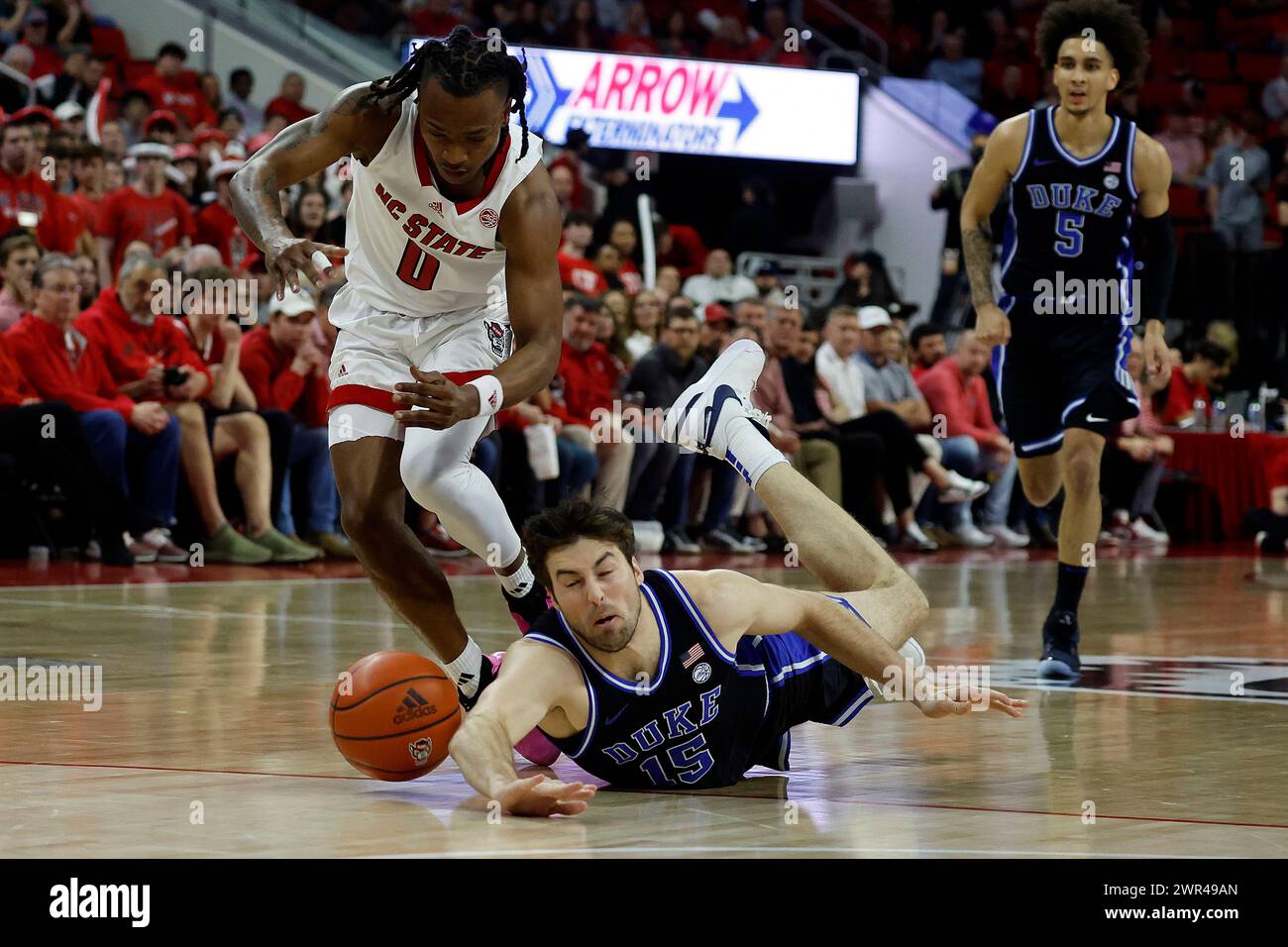 North Carolina State's DJ Horne (0) and Duke's Ryan Young (15) dive for ...