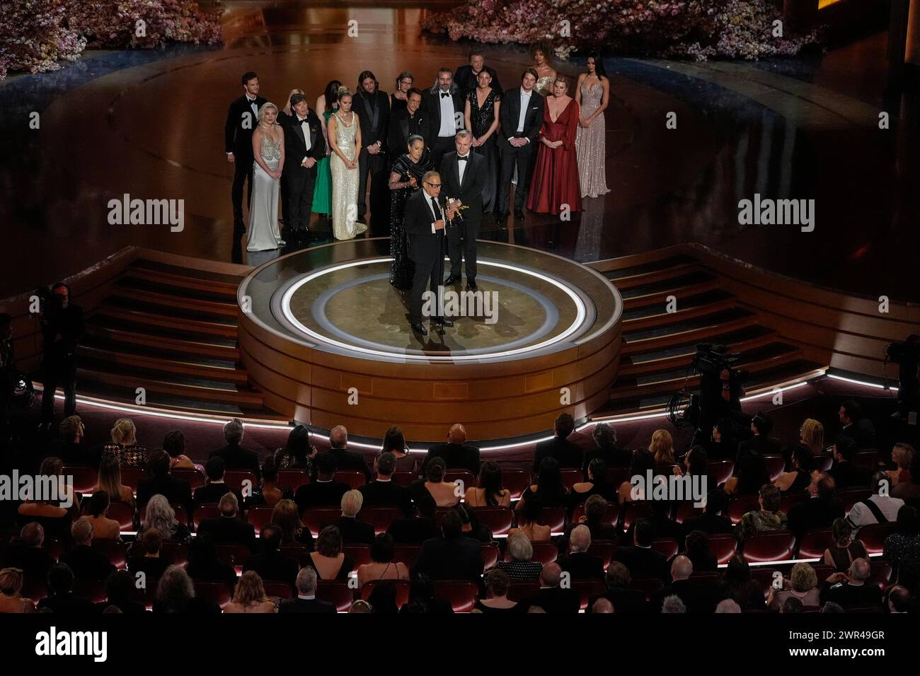 The cast and crew of "Oppenheimer" accept the award for best picture ...