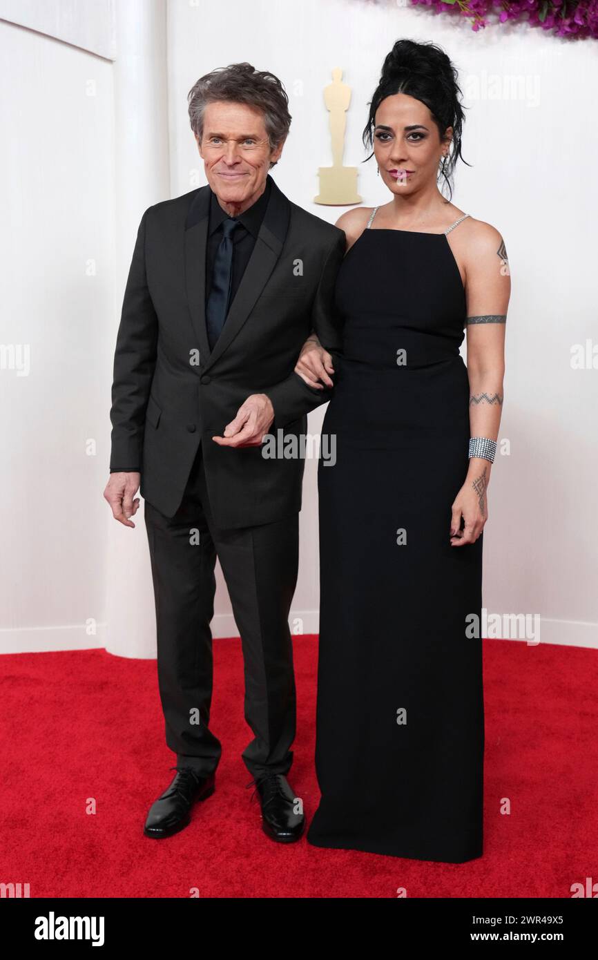 Willem Dafoe, from left and Giada Colagrande arrive at the Oscars on Sunday, March 10, 2024, at ...