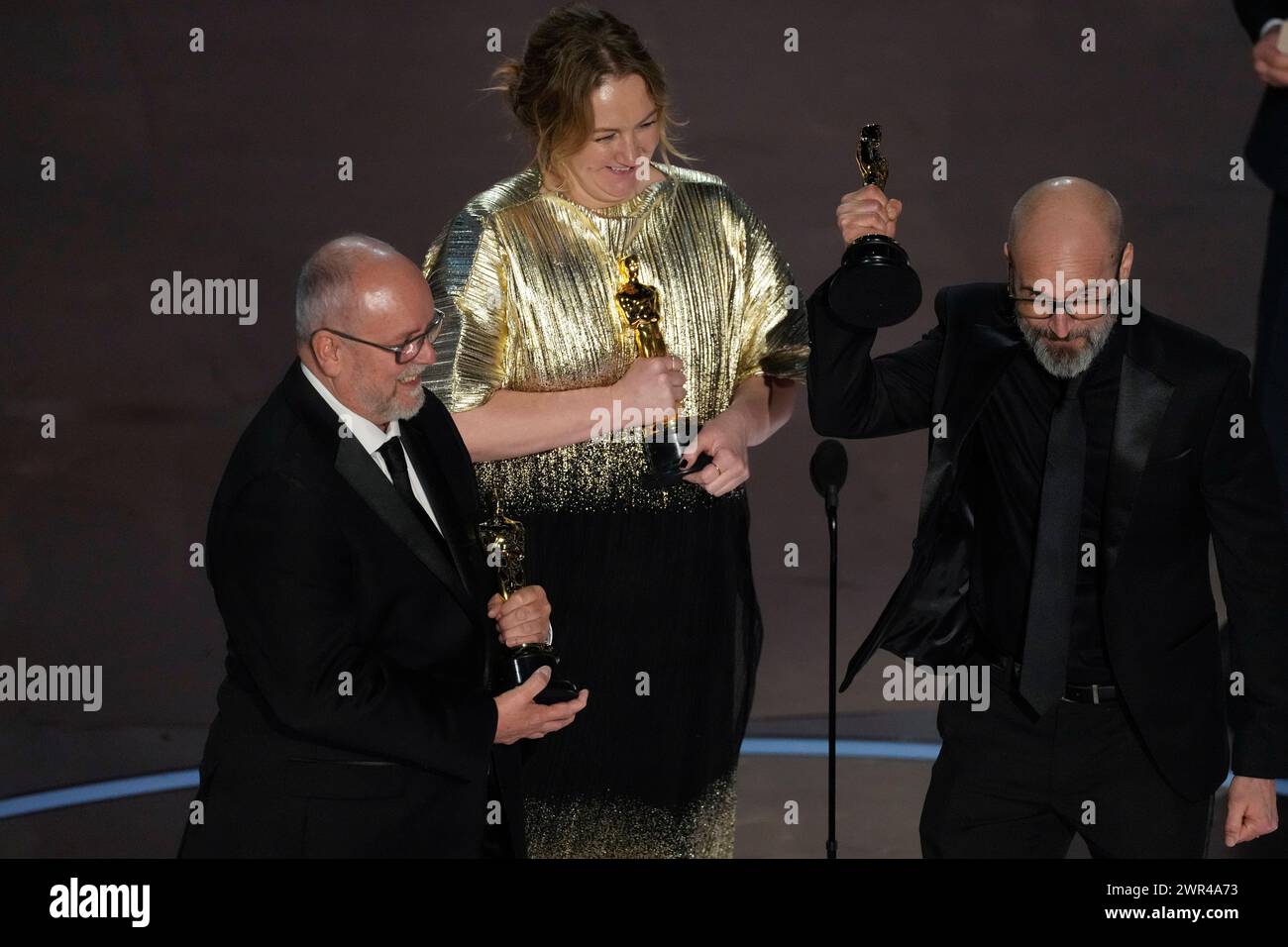 Mark Coulier, from left, Nadia Stacey and Josh Weston accept the award ...