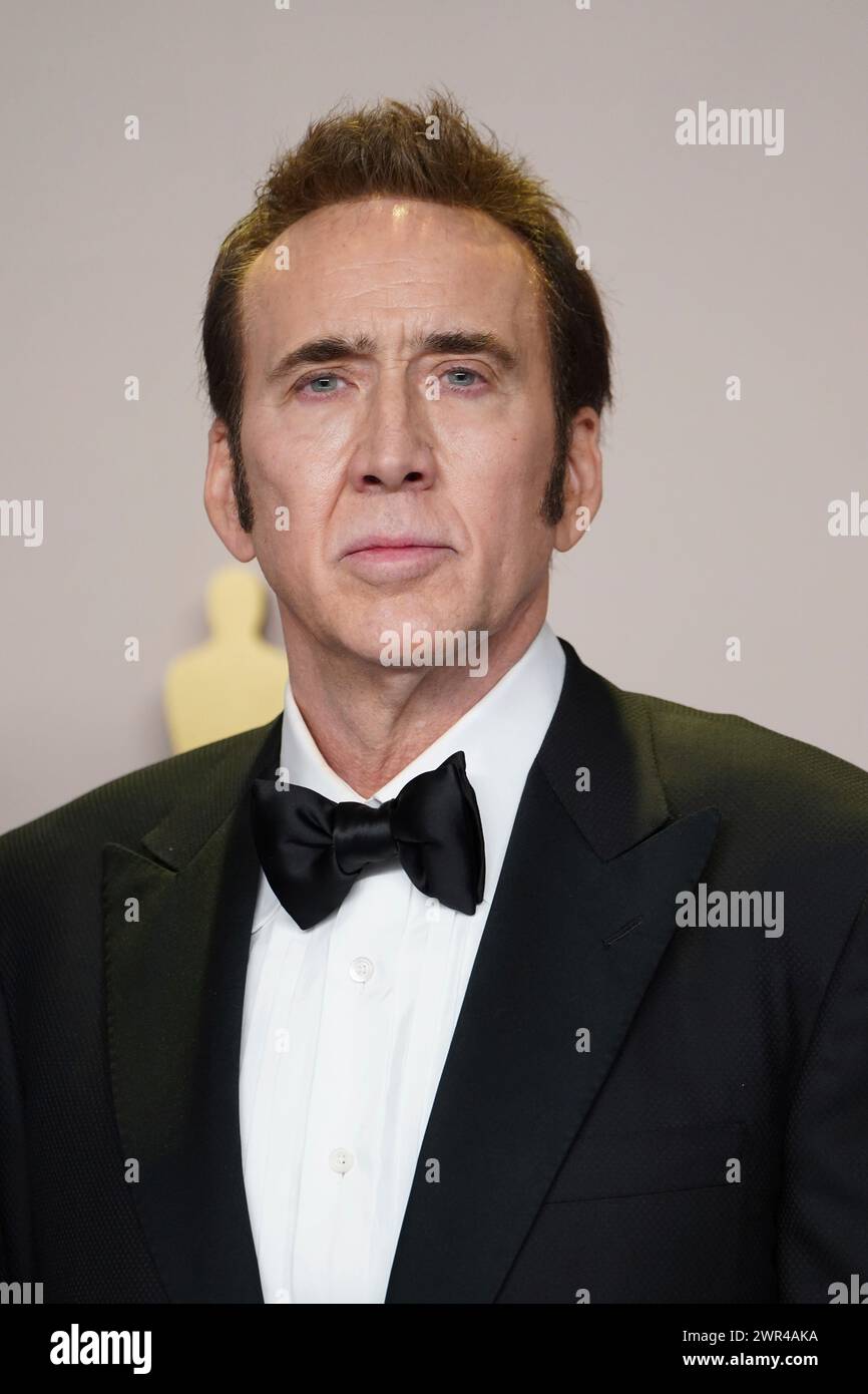 Nicolas Cage poses in the press room at the Oscars on Sunday, March 10 ...