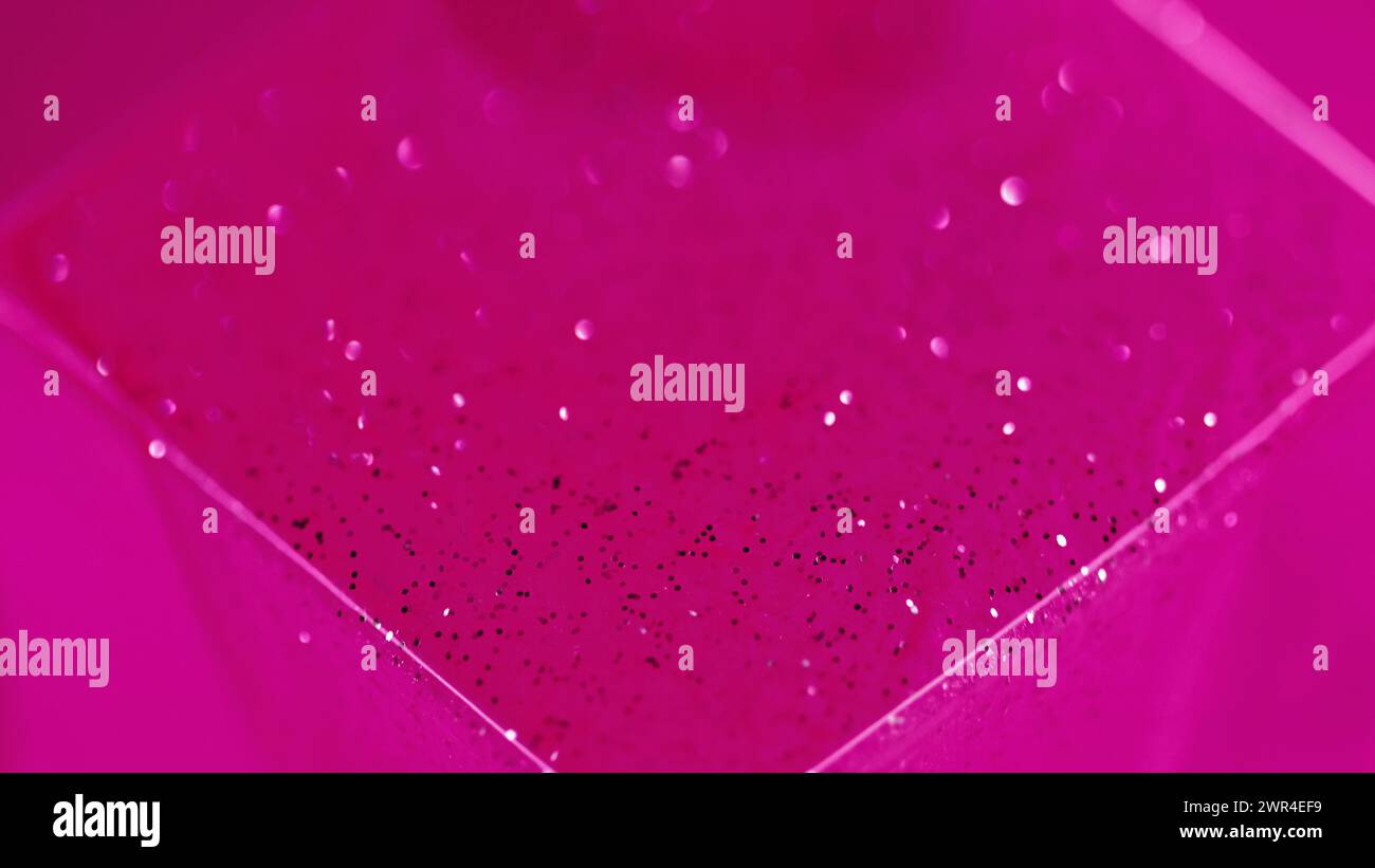 Glitter ink shimmering spill pink paint gel cube Stock Photo - Alamy